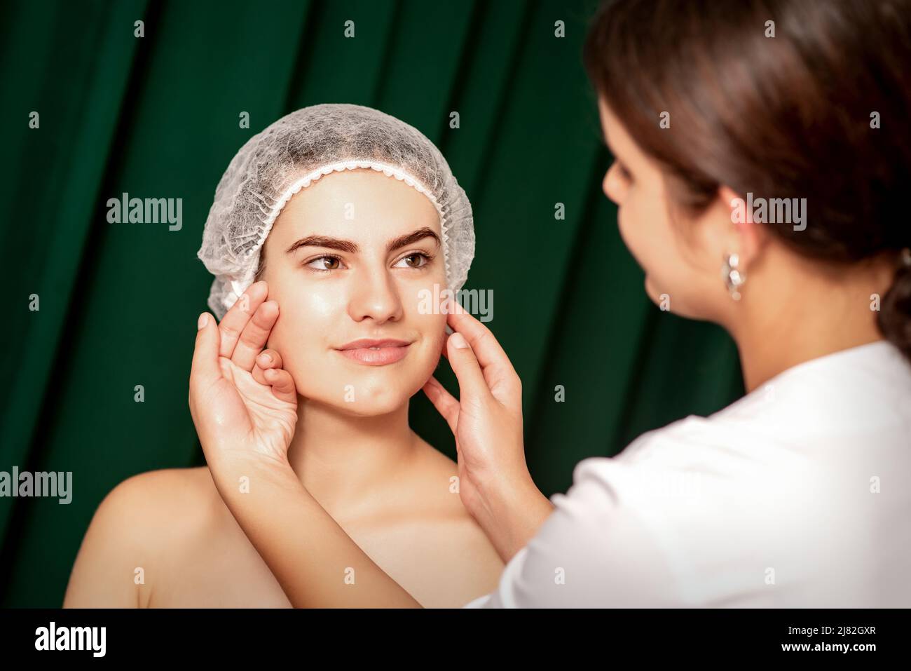 Plastic surgery and beauty concept. Professional cosmetician examining ...