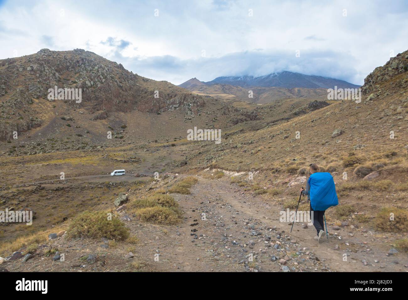 Tourists hike to the snow-capped and dormant compound volcano Mount ...