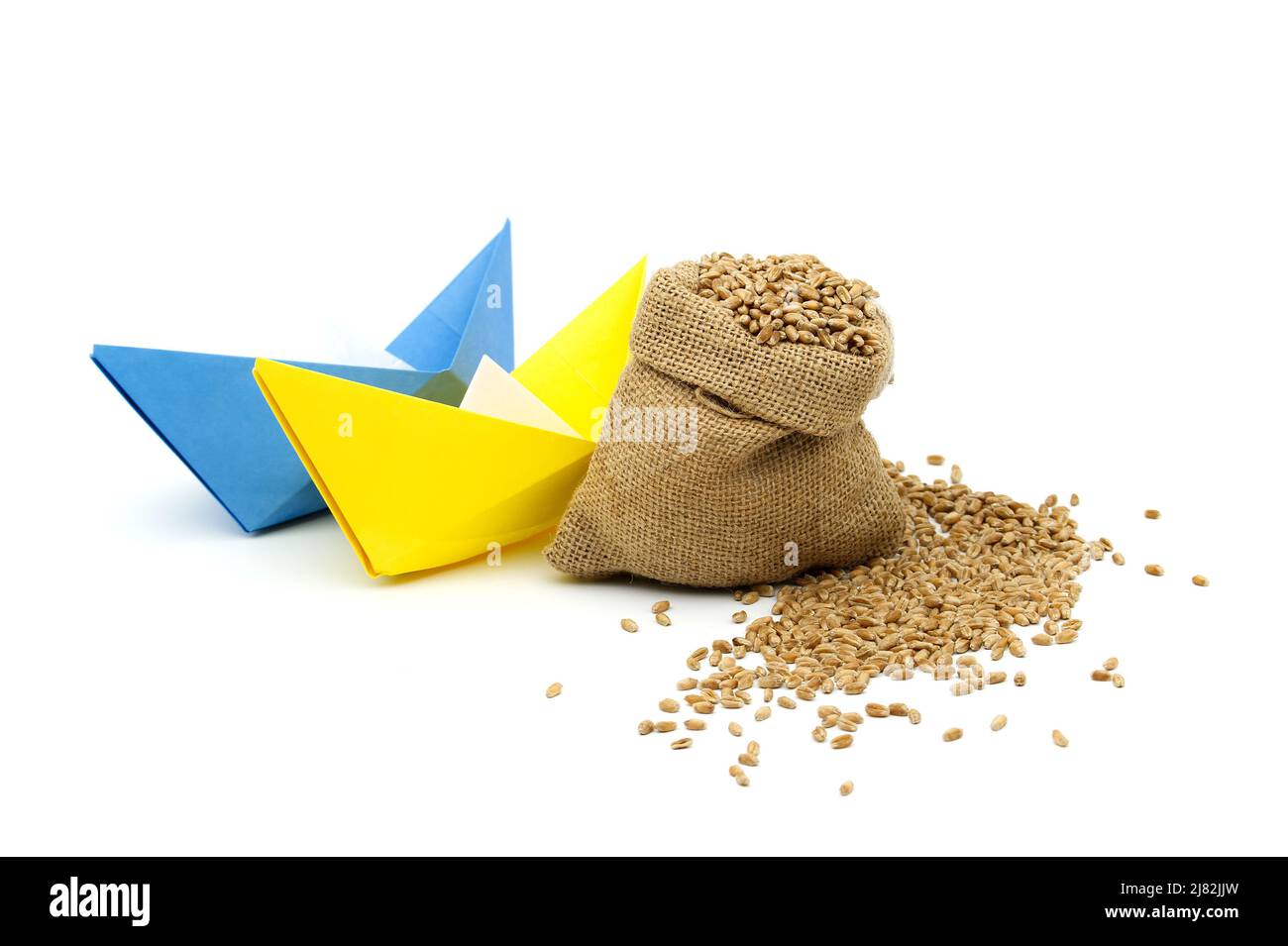 Ukrainian flag colors origami boats and Wheat seeds spilling from a ...