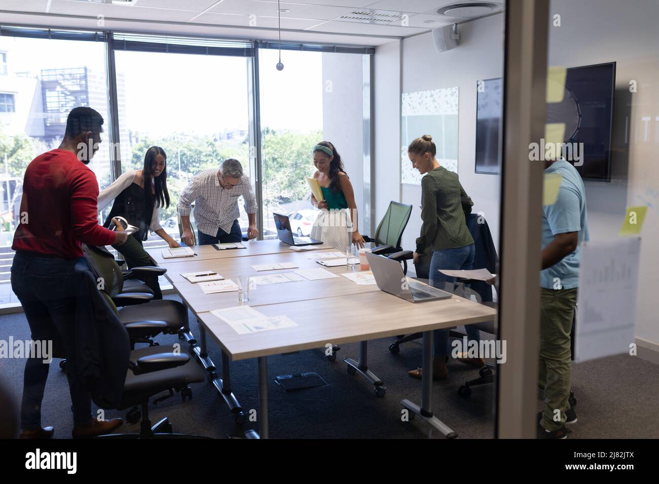 Multiracial male and female business colleagues attending meeting in ...