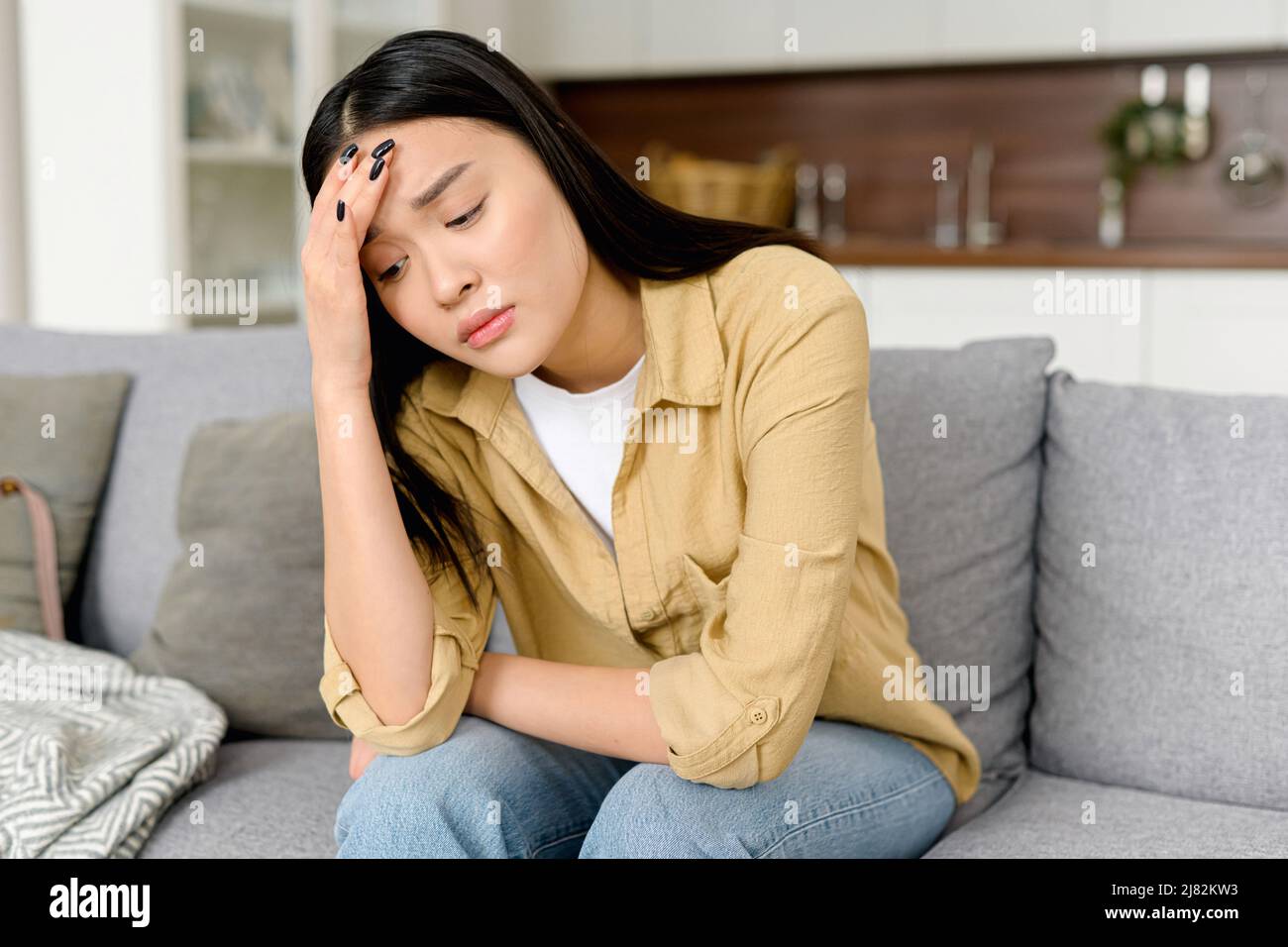 Stressed young asian woman touching head and feels dizzy, suffering ...