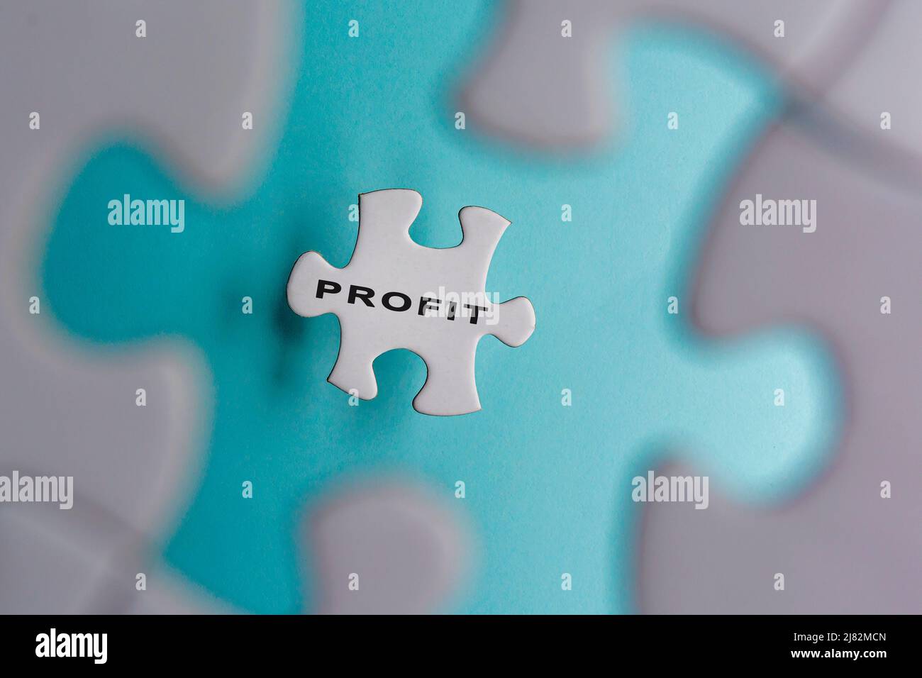 Profit word on puzzle pieces isolated on blue background. Business ...