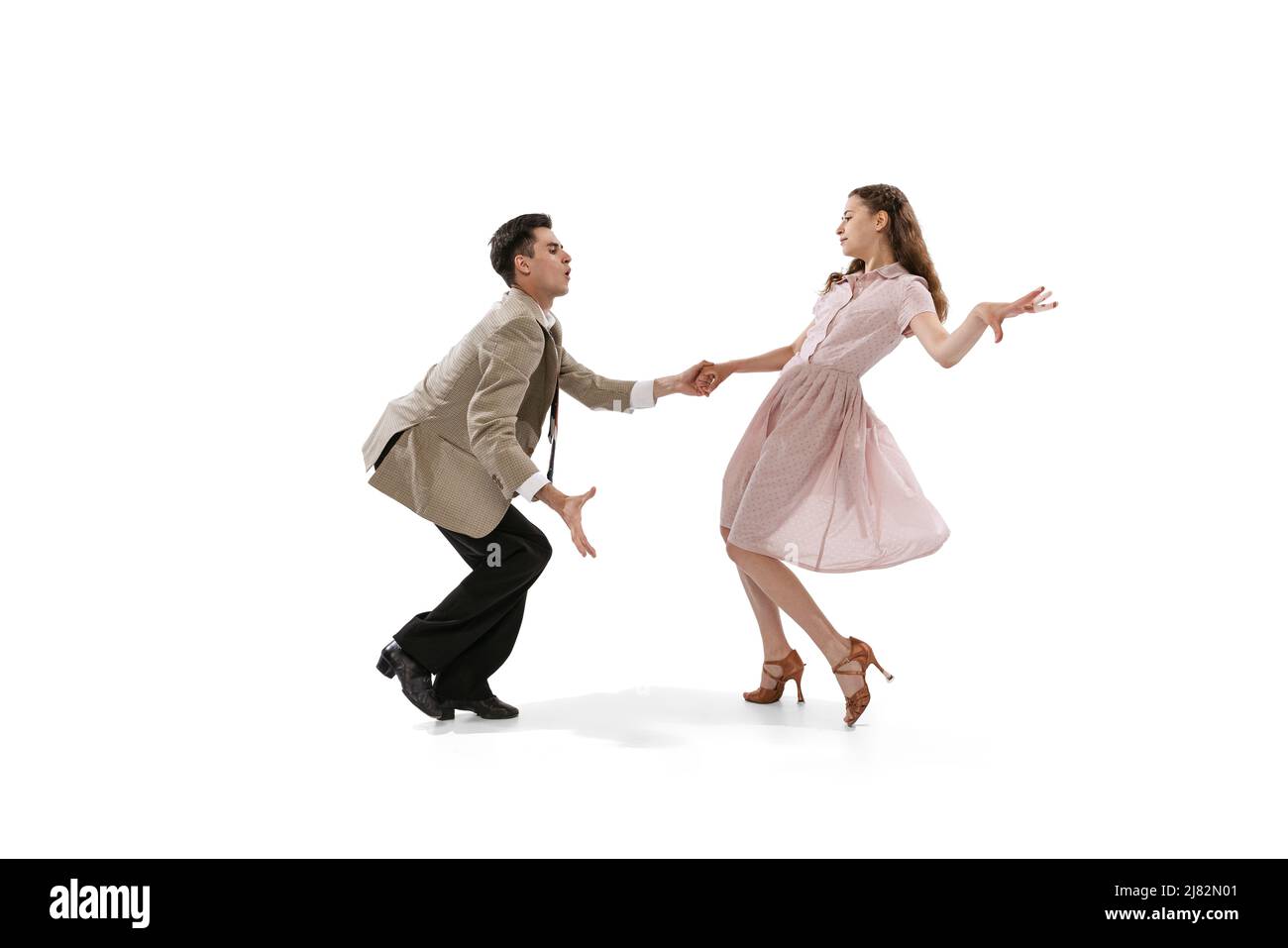 Young man and woman in vintage retro style outfits dancing social dance ...