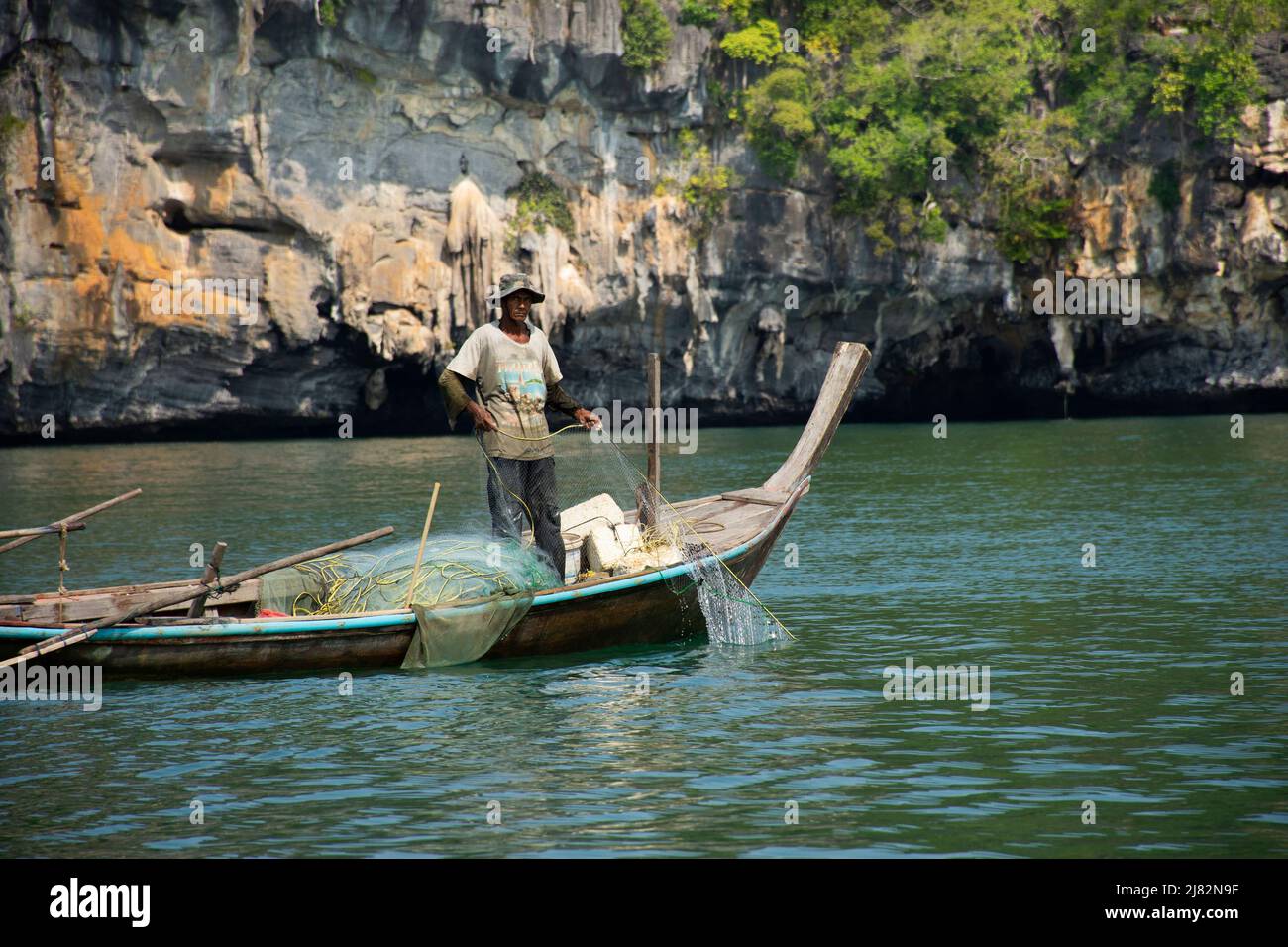 Thai man fisher people sailing wood long tail boat fishery floating in ...