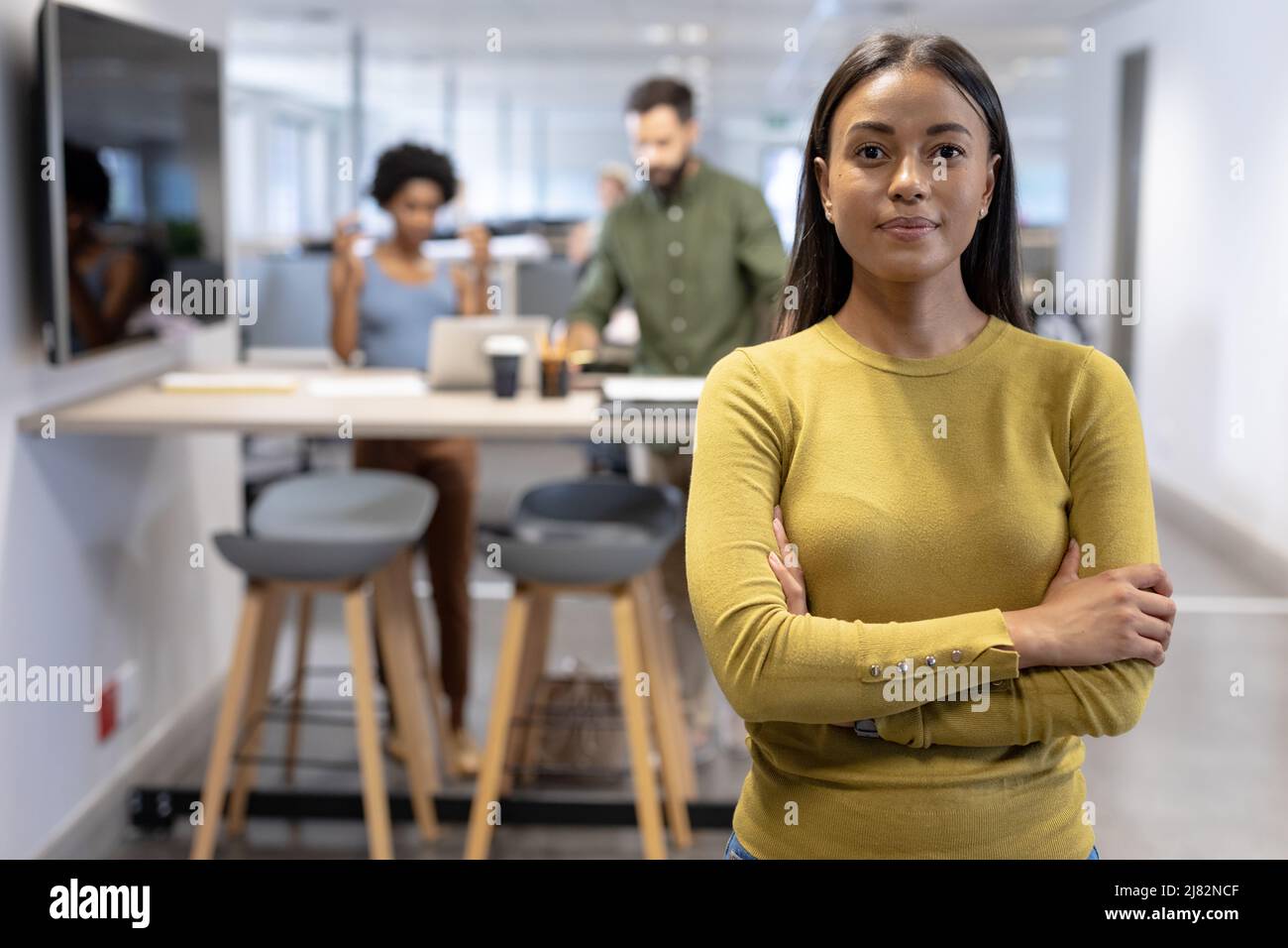Portrait of confident young african american female advisor standing ...