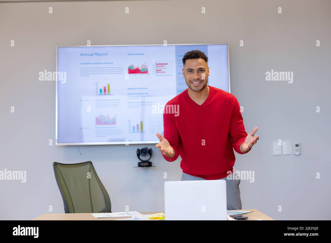 Portrait of smiling hispanic male advisor explaining plan while giving ...