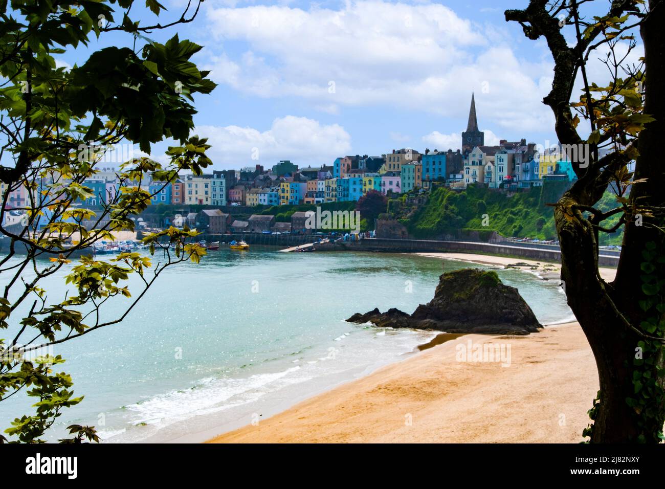 Tenby Beach on a sunny day North beach iconic colourful houses Stock ...