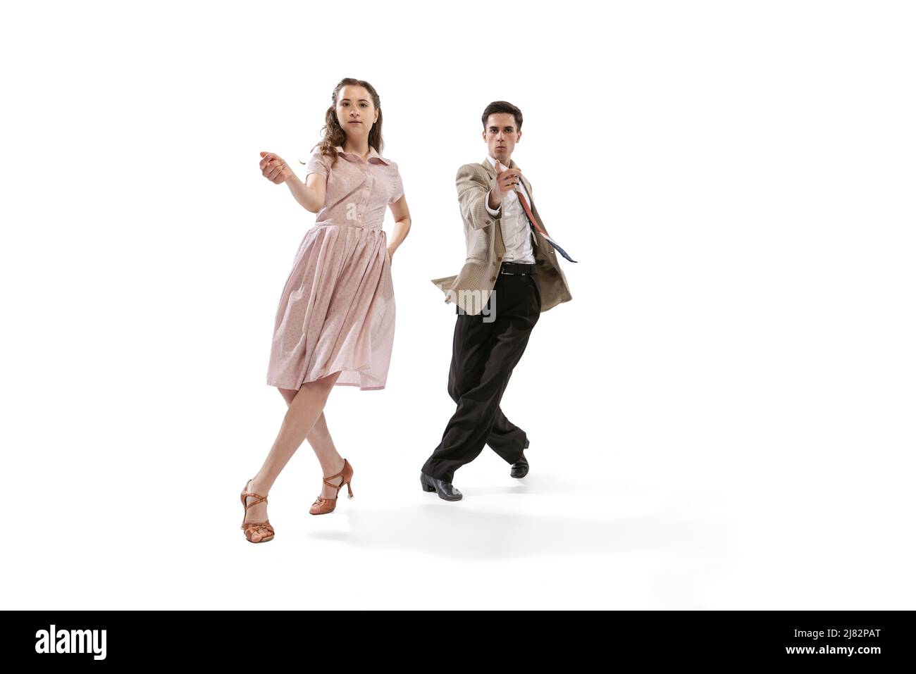 Young man and woman in vintage retro style outfits dancing social dance ...