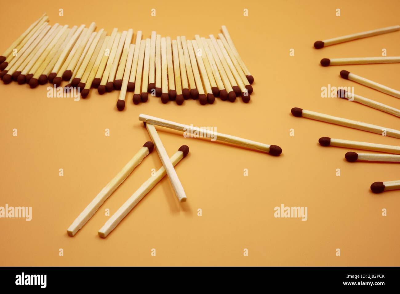 pile of matchstick on yellow background Stock Photo - Alamy