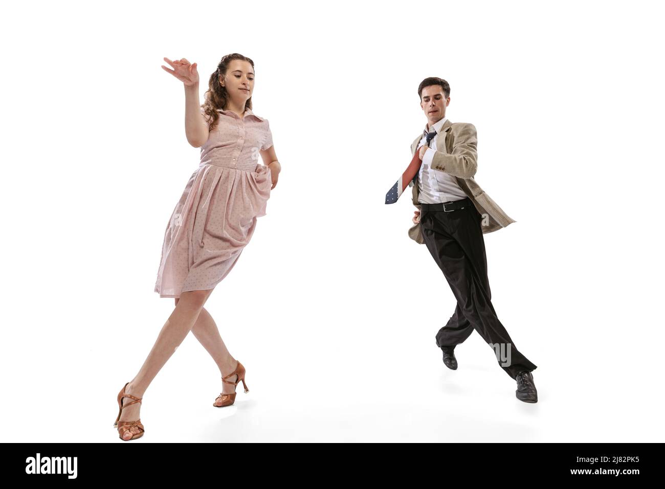 Young man and woman in vintage retro style outfits dancing social dance ...