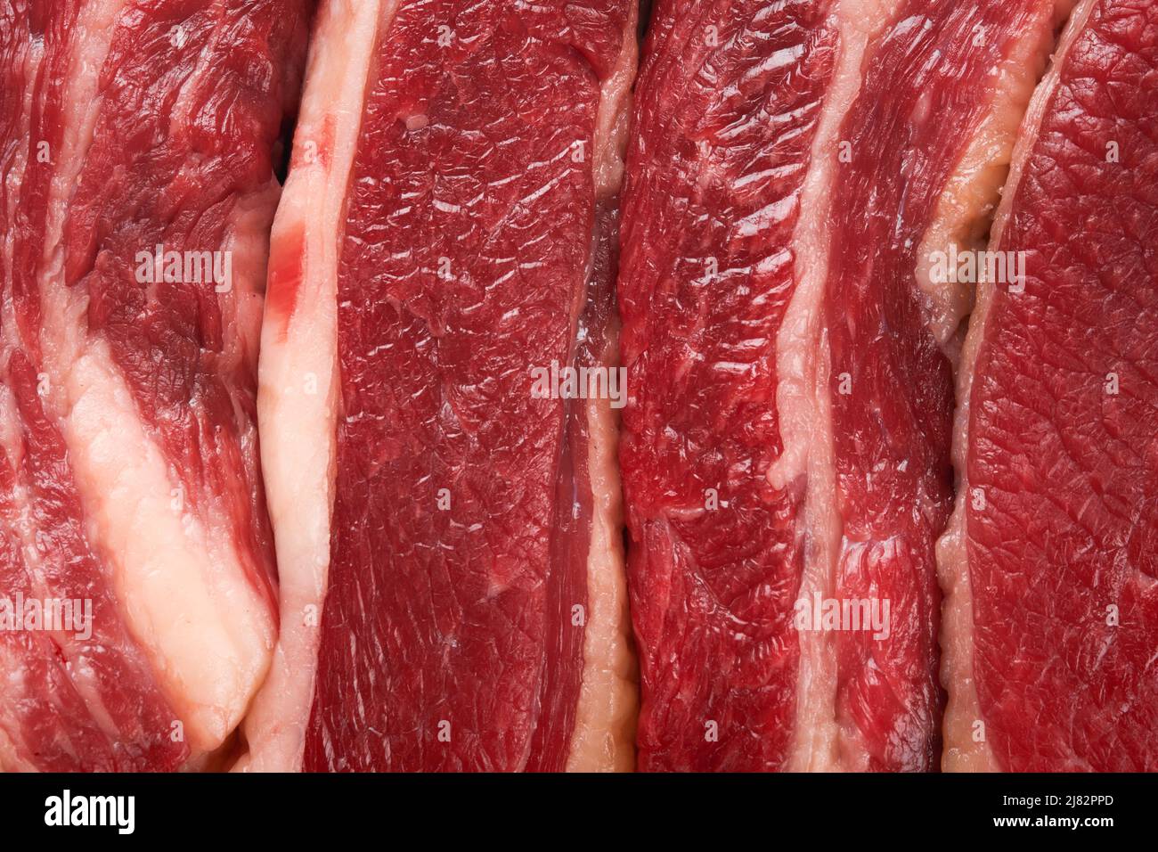 Texture or background steak beef. Raw steak New York with rosemary and ...
