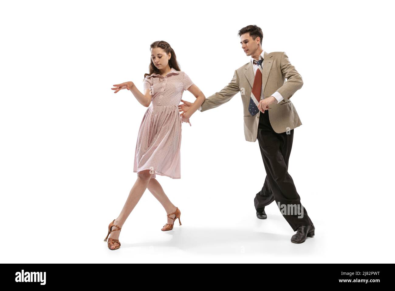 Young man and woman in vintage retro style outfits dancing social dance ...