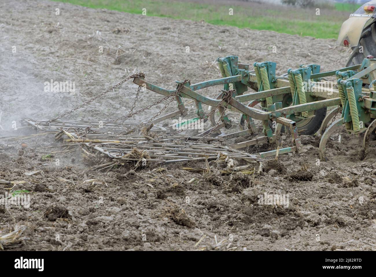 Tractor crushes soil for ready to sowing crops Stock Photo - Alamy