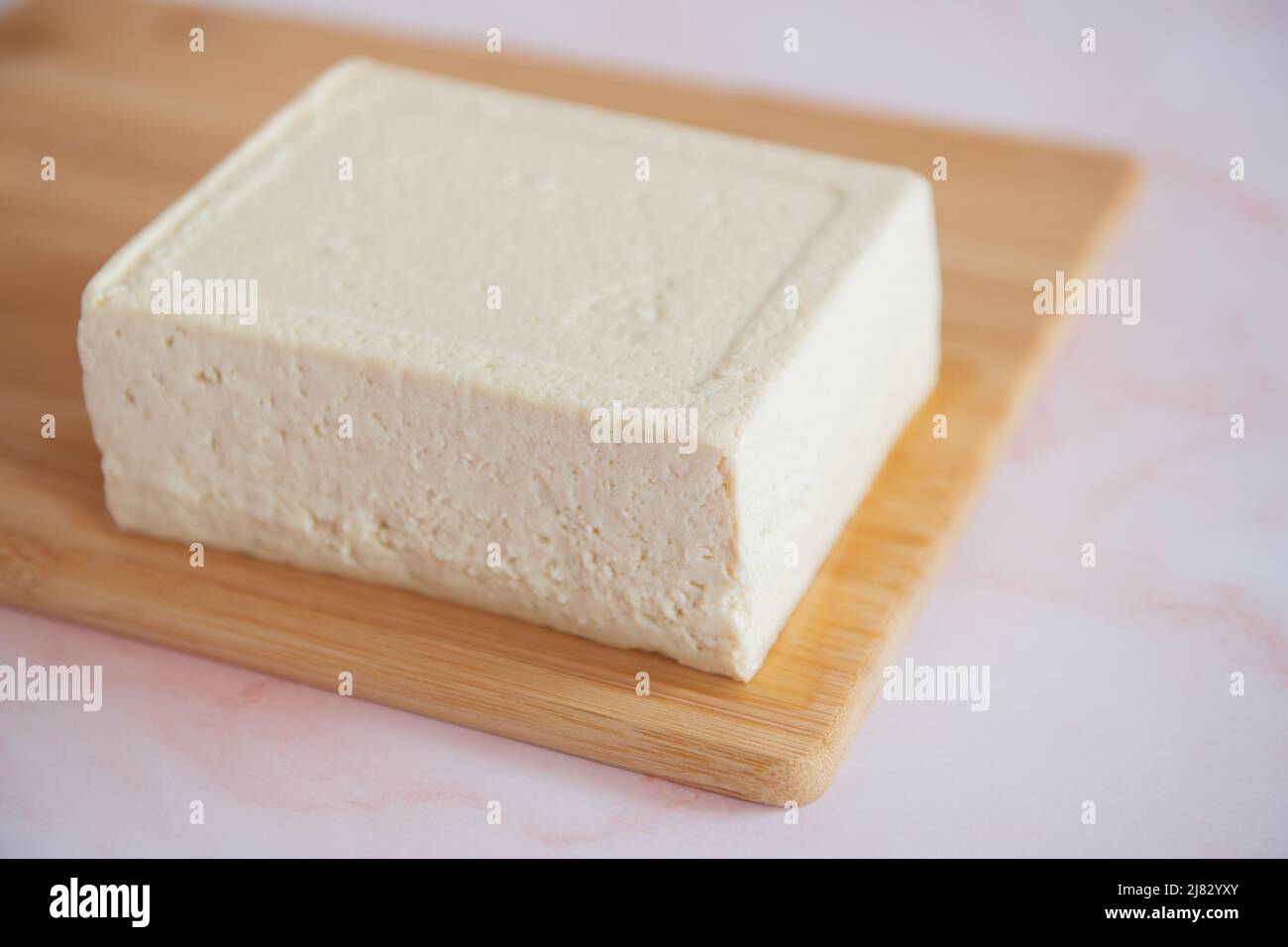 Block of tofu on a cutting board Stock Photo - Alamy