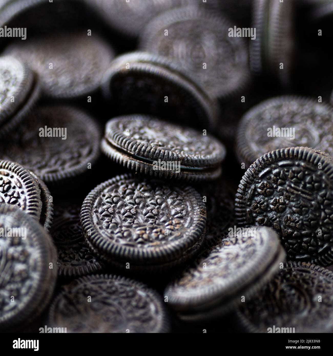 Textured dark background with circle shape cookies black color ...