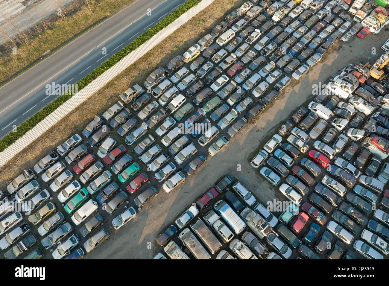 Aerial view of big parking lot of junkyard with rows of discarded ...
