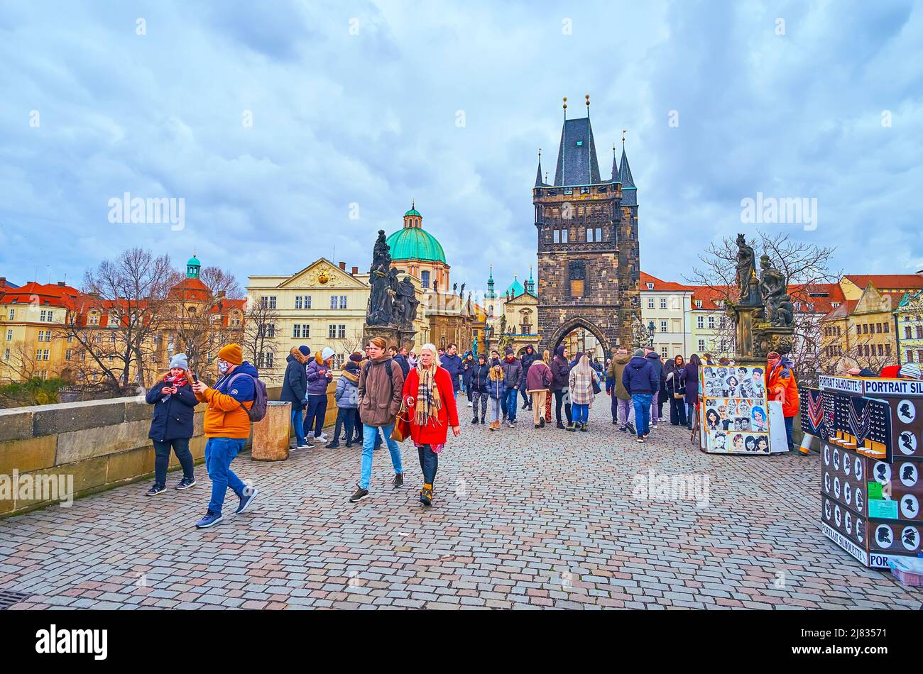 PRAGUE, CZECH REPUBLIC - MARCH 5, 2022: The crowded Charles Bridge with Old Town Bridge Tower ...