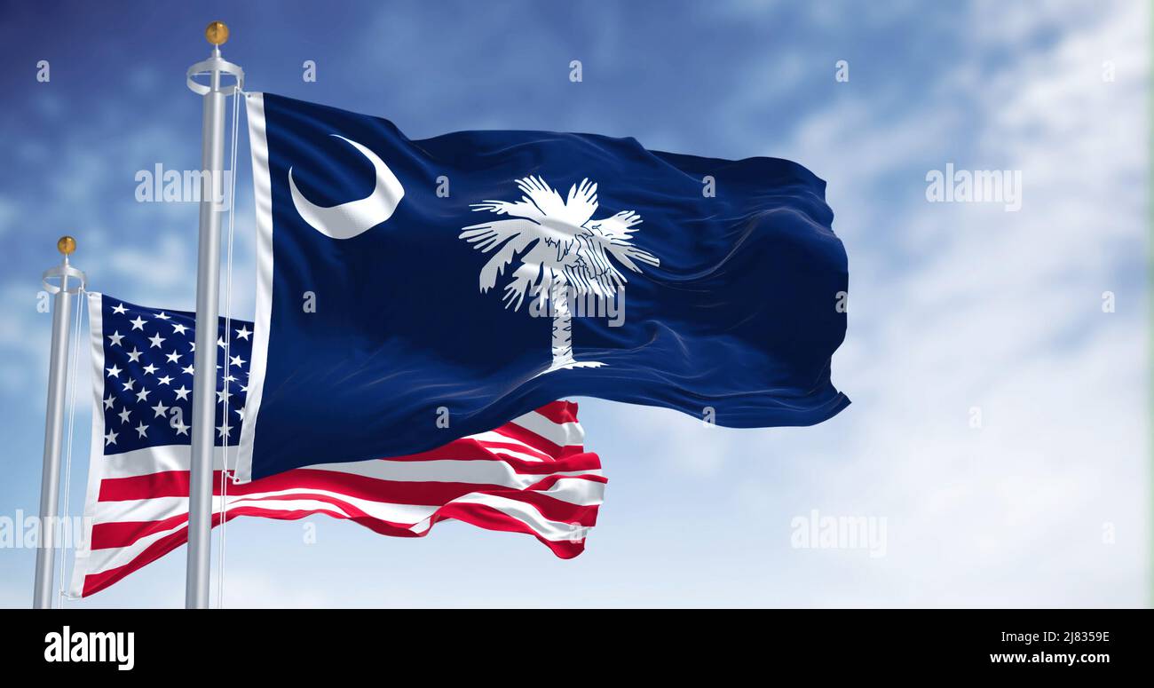 The South Carolina state flag waving along with the national flag of ...