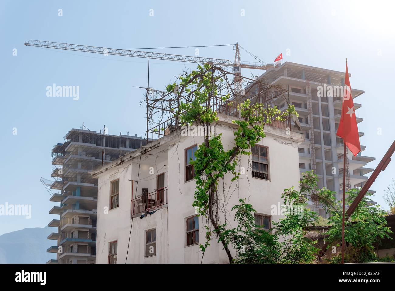 An old Turkish house against the backdrop of modern tall residential ...