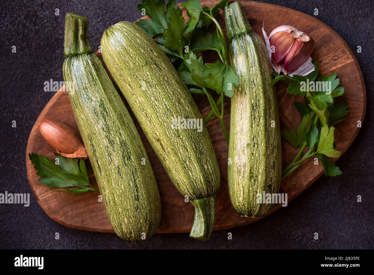 Fresh zucchini on wooden cutting board, healthy vegetable meal Stock ...