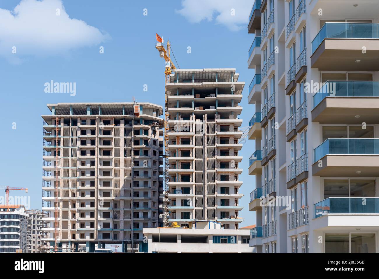 The process of construction of residential buildings against the blue ...