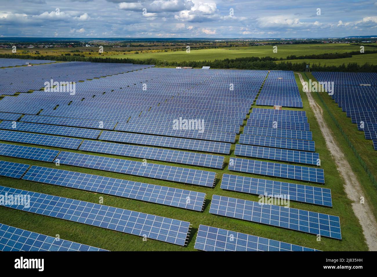 Aerial view of big sustainable electric power plant with many rows of ...