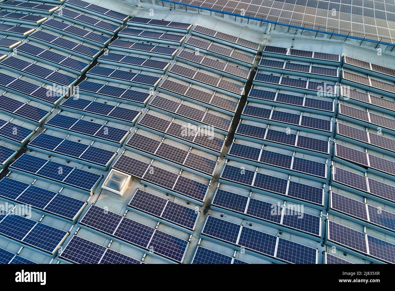 Aerial view of blue photovoltaic solar panels mounted on industrial ...