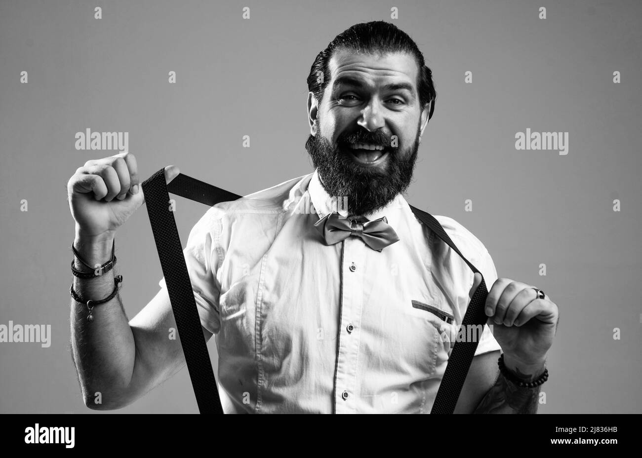 trendy man in suspenders and bow tie. confident and elegant man in ...