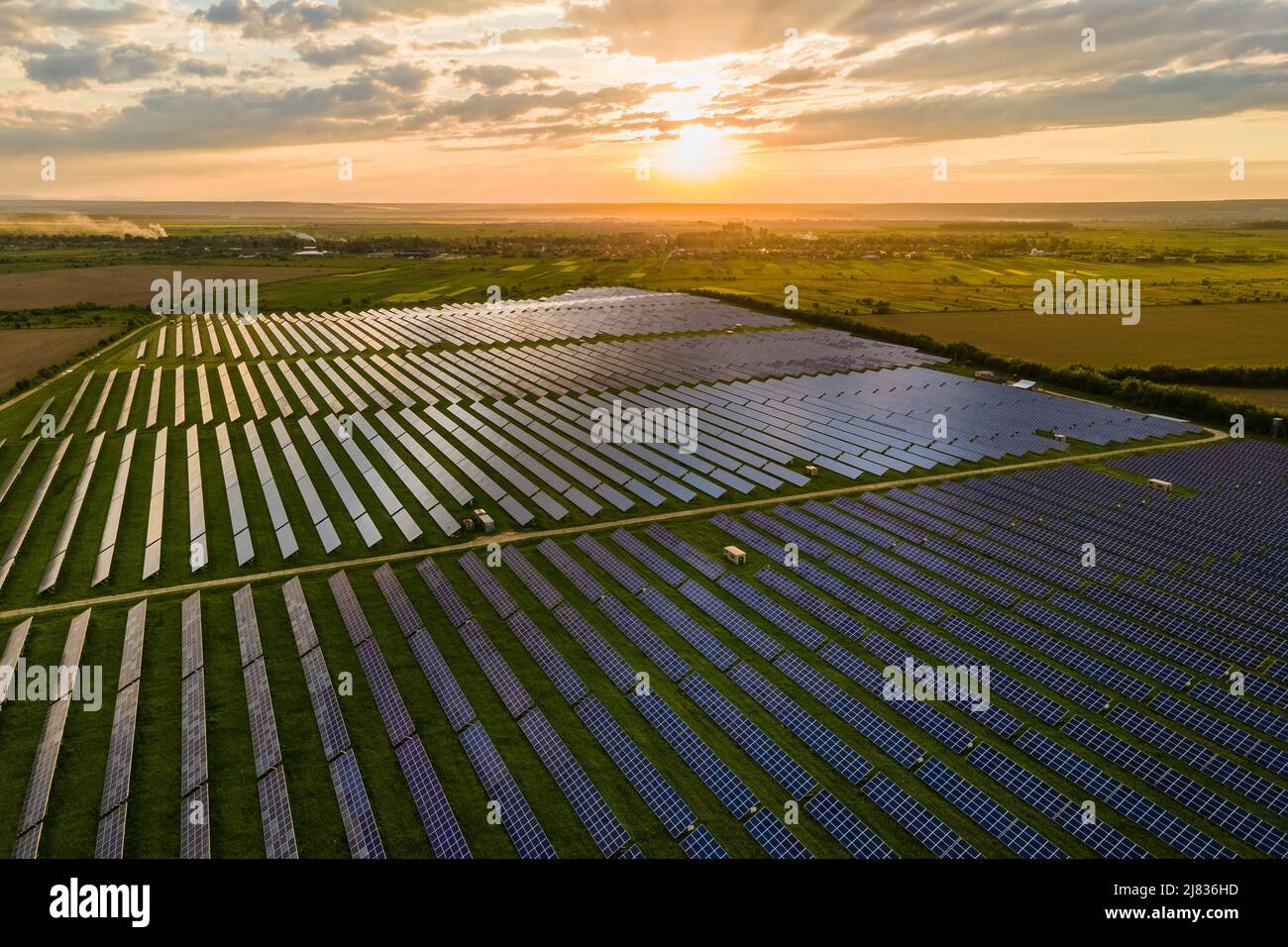 Aerial view of large sustainable electrical power plant with many rows ...