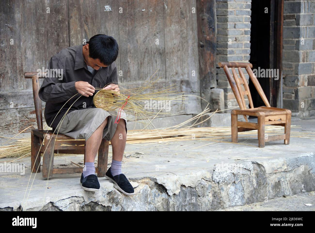 Fenghuang, Hunan Province, China: A man making a basket by hand. Basket ...