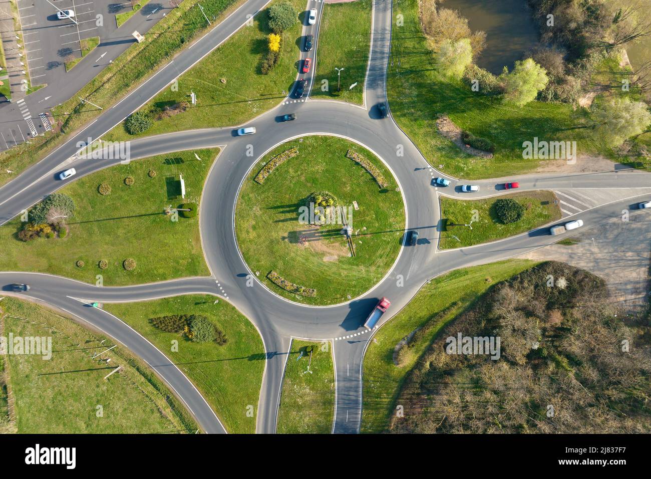 Aerial view of road roundabout intersection with moving heavy traffic ...