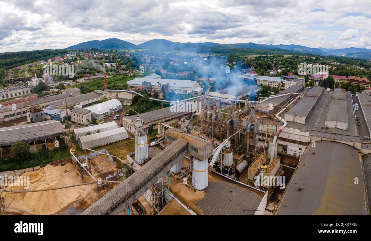 Aerial view of wood processing factory with smoke from production ...
