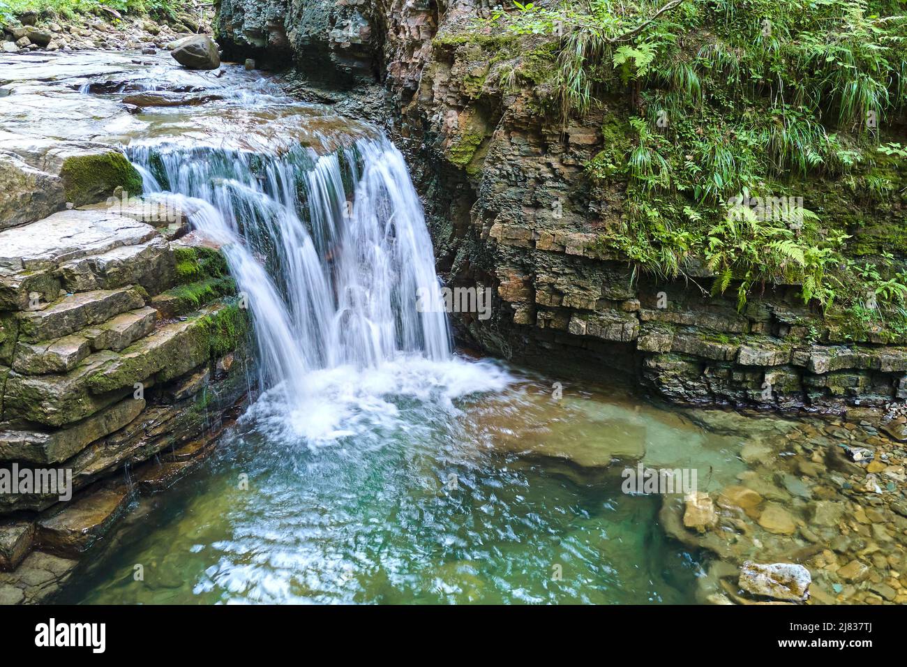 Amazing landscape of beautiful waterfall on mountain river with white ...