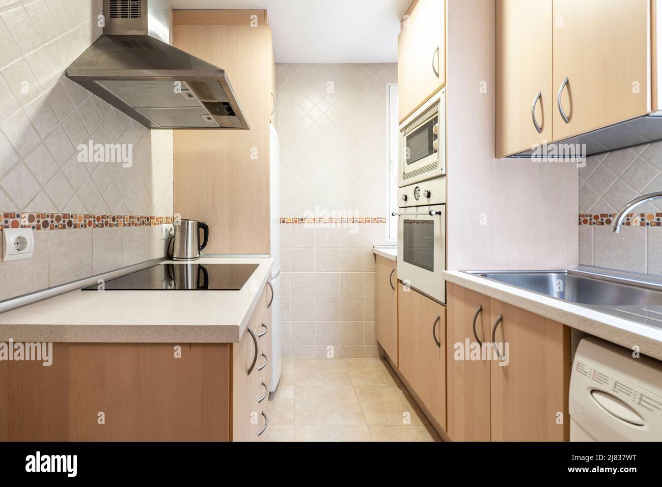 full kitchen with white column ovens, matching washing machine, white ...