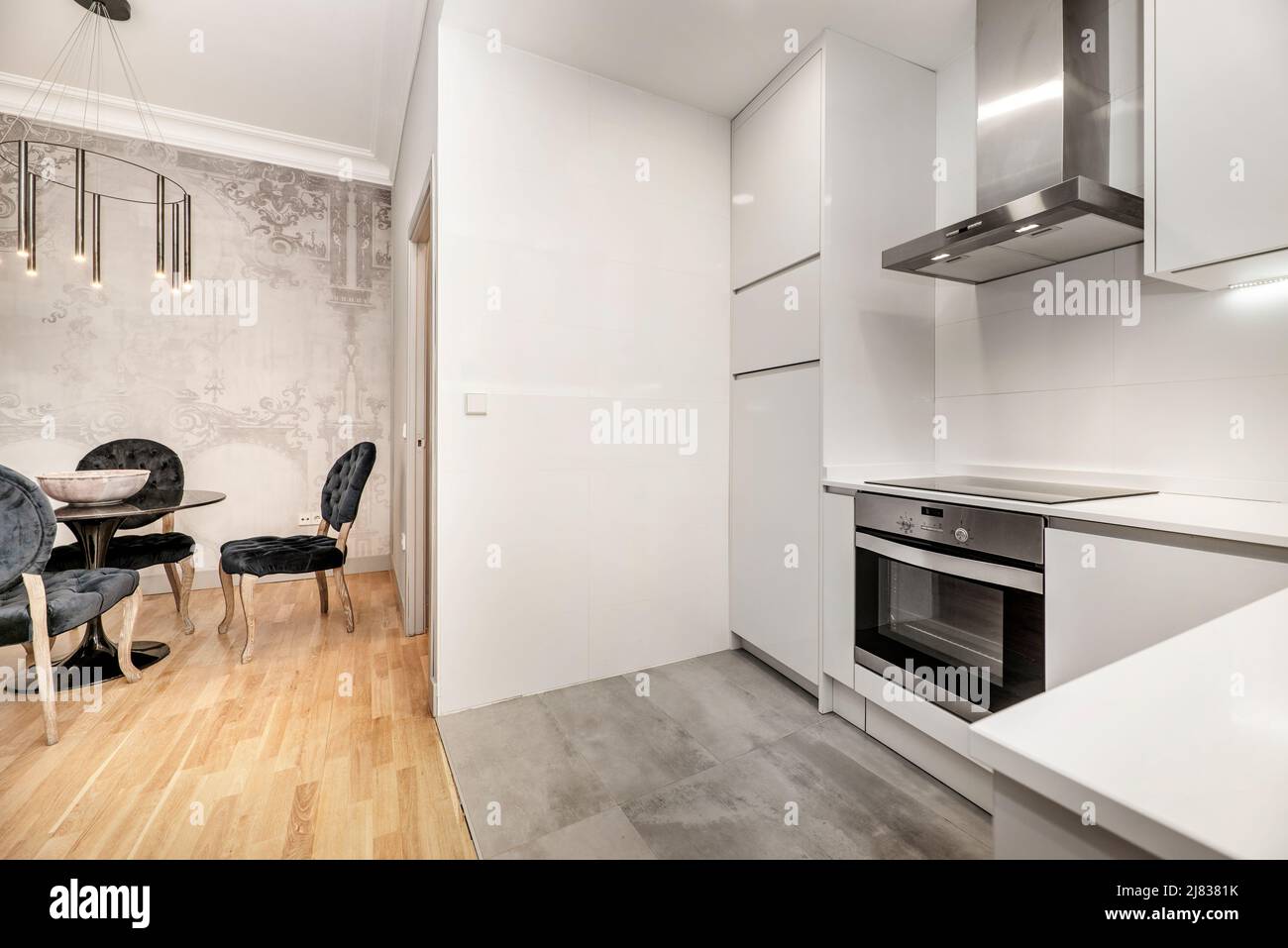 Apartment kitchen with white cabinets, white stone countertops ...