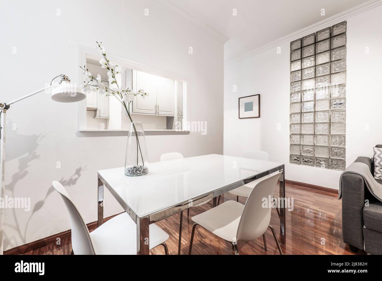 White glass dining table with chrome metal brick skylight wall with ...
