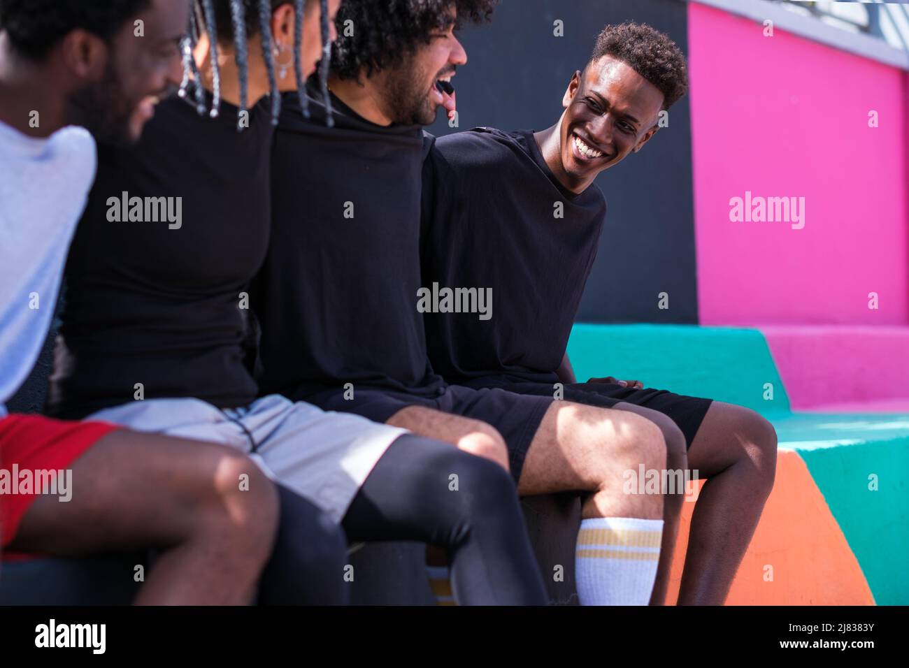 Four friends talking and having fun together on the street Stock Photo ...