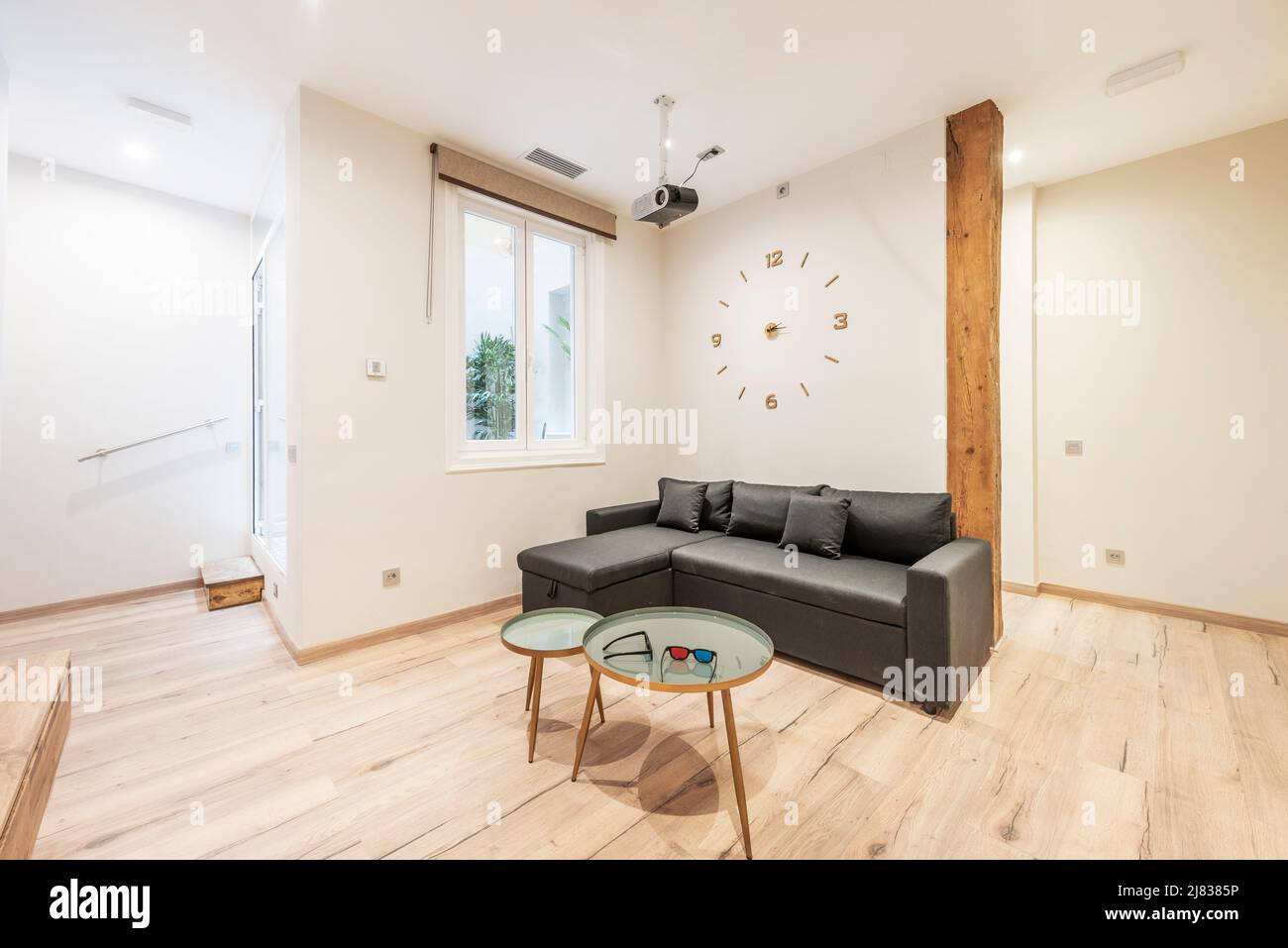 Cinema room with projector, sofa upholstered in dark fabric, 3d glasses ...