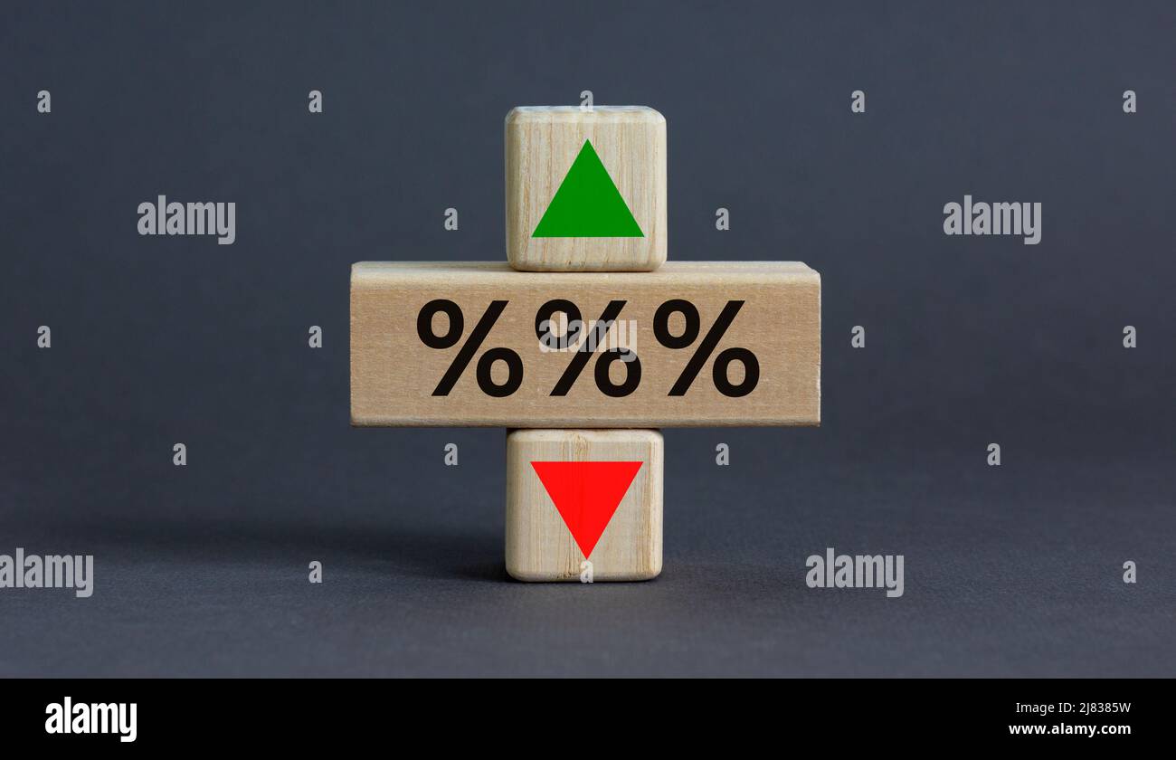 Interest rates symbol. A wooden cube with an arrow symbolizing that the ...