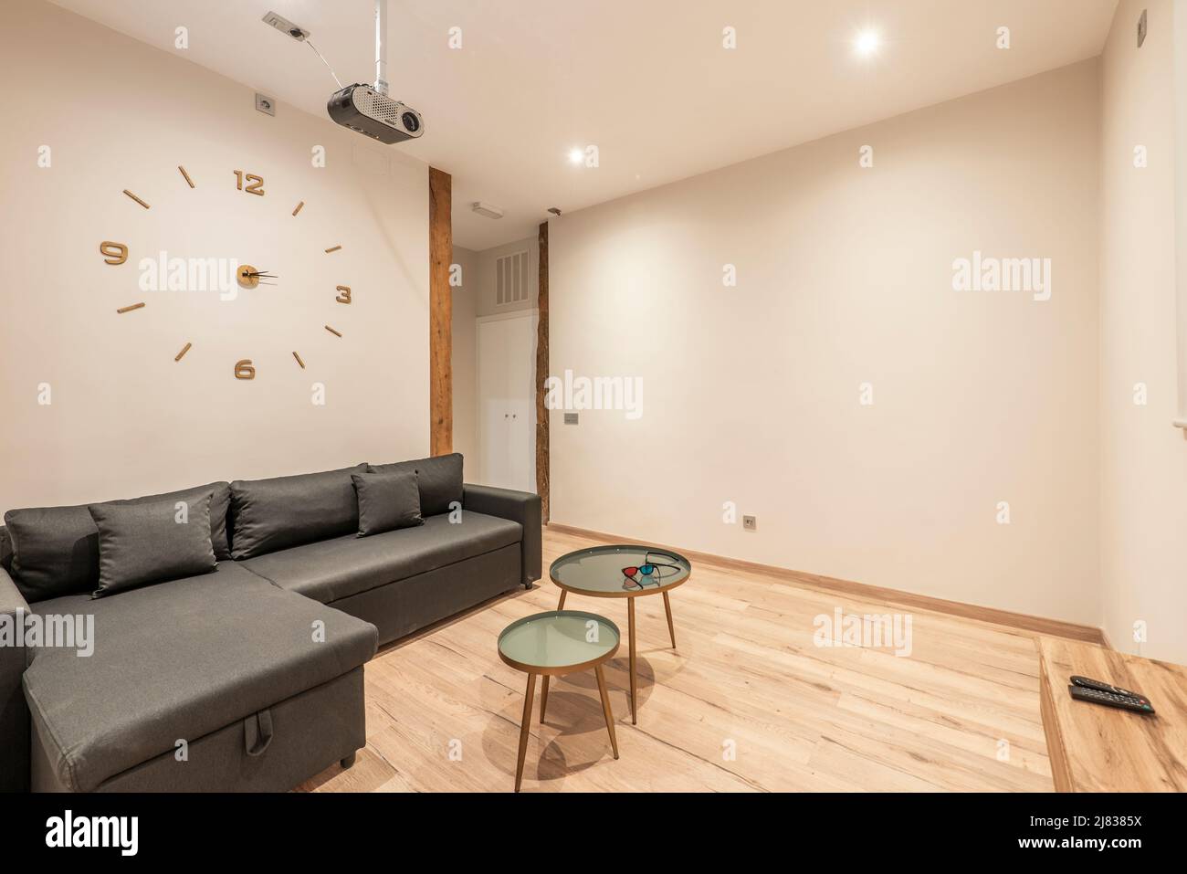 Cinema room with projector, sofa upholstered in dark fabric, 3d glasses ...