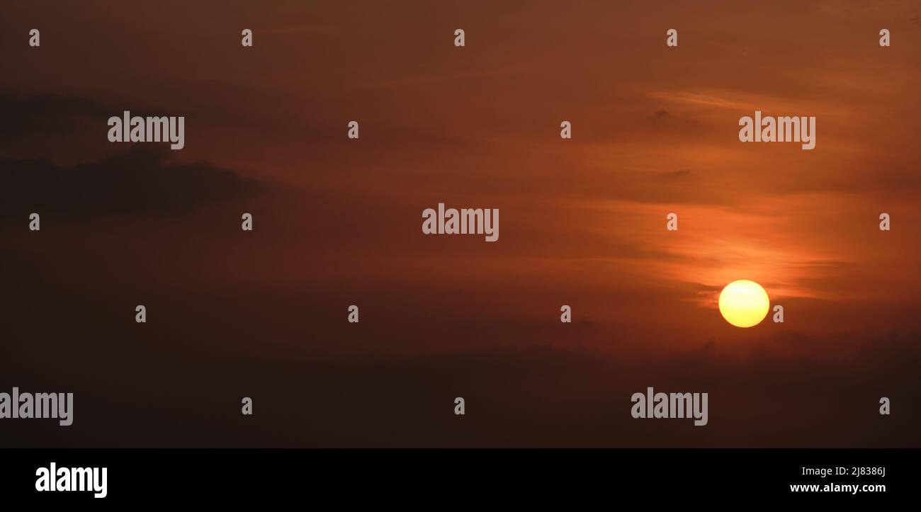 Bright colorful sunset sky with rays of setting sun and vivid dark ...