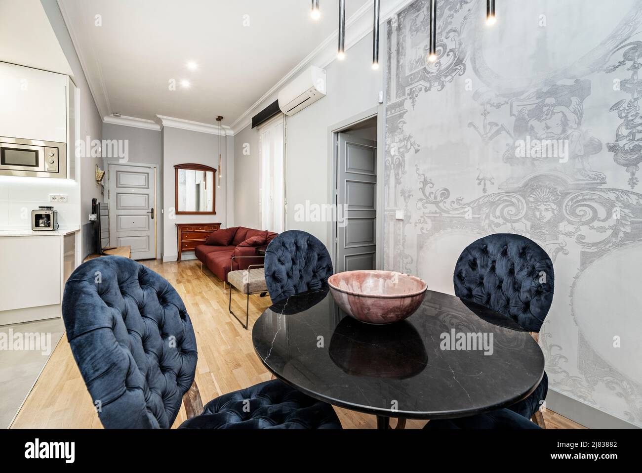 Living room with small circular black marble dining table, capitone ...