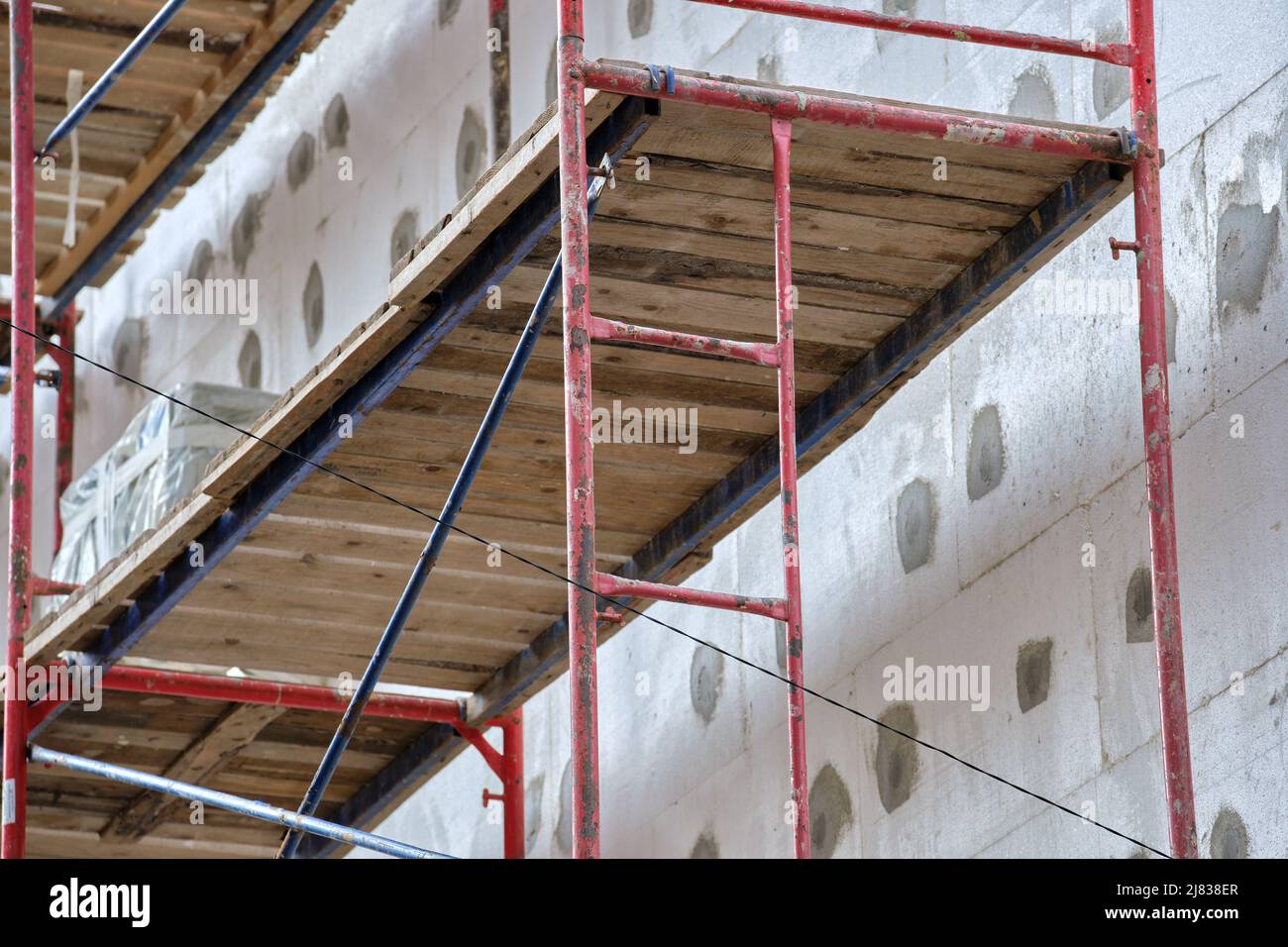 Building facade under renovation works with construction scaffolding ...