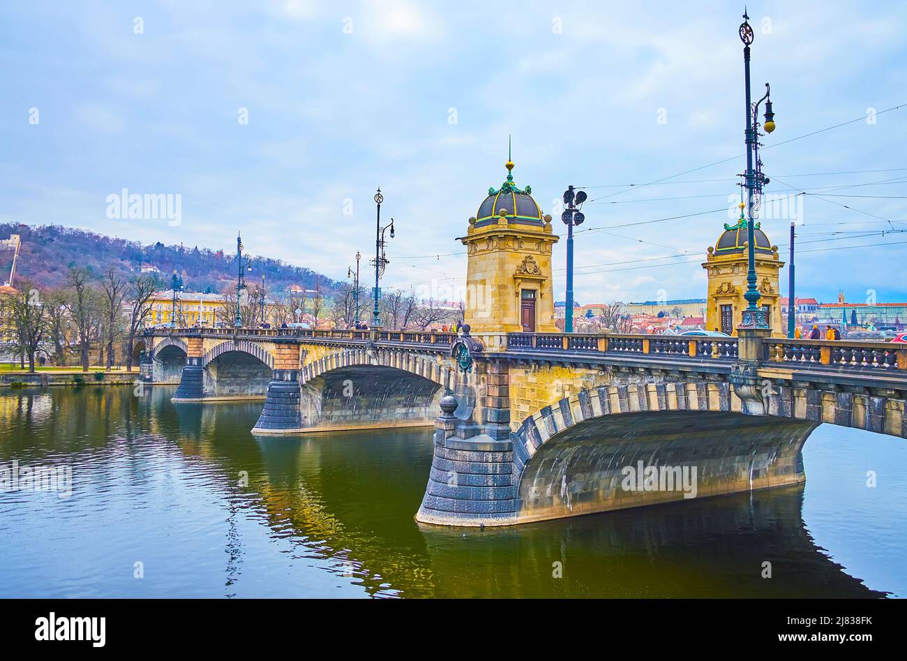 The carved stone arched Legion Bridge across Vltava River, Prague ...