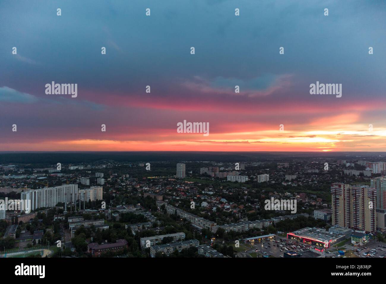Beautiful colorful sunset above city residential district, aerial view ...