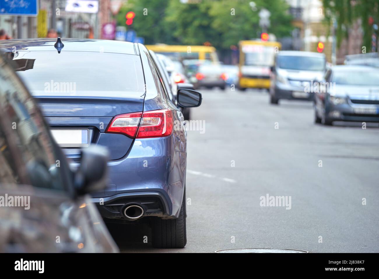 City traffic with cars parked in line on street side Stock Photo - Alamy