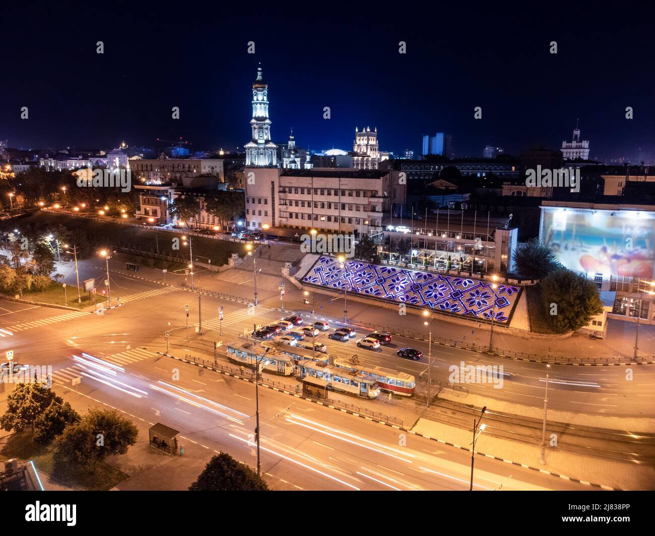 Aerial view on night city center streets with tram and cars driving in ...