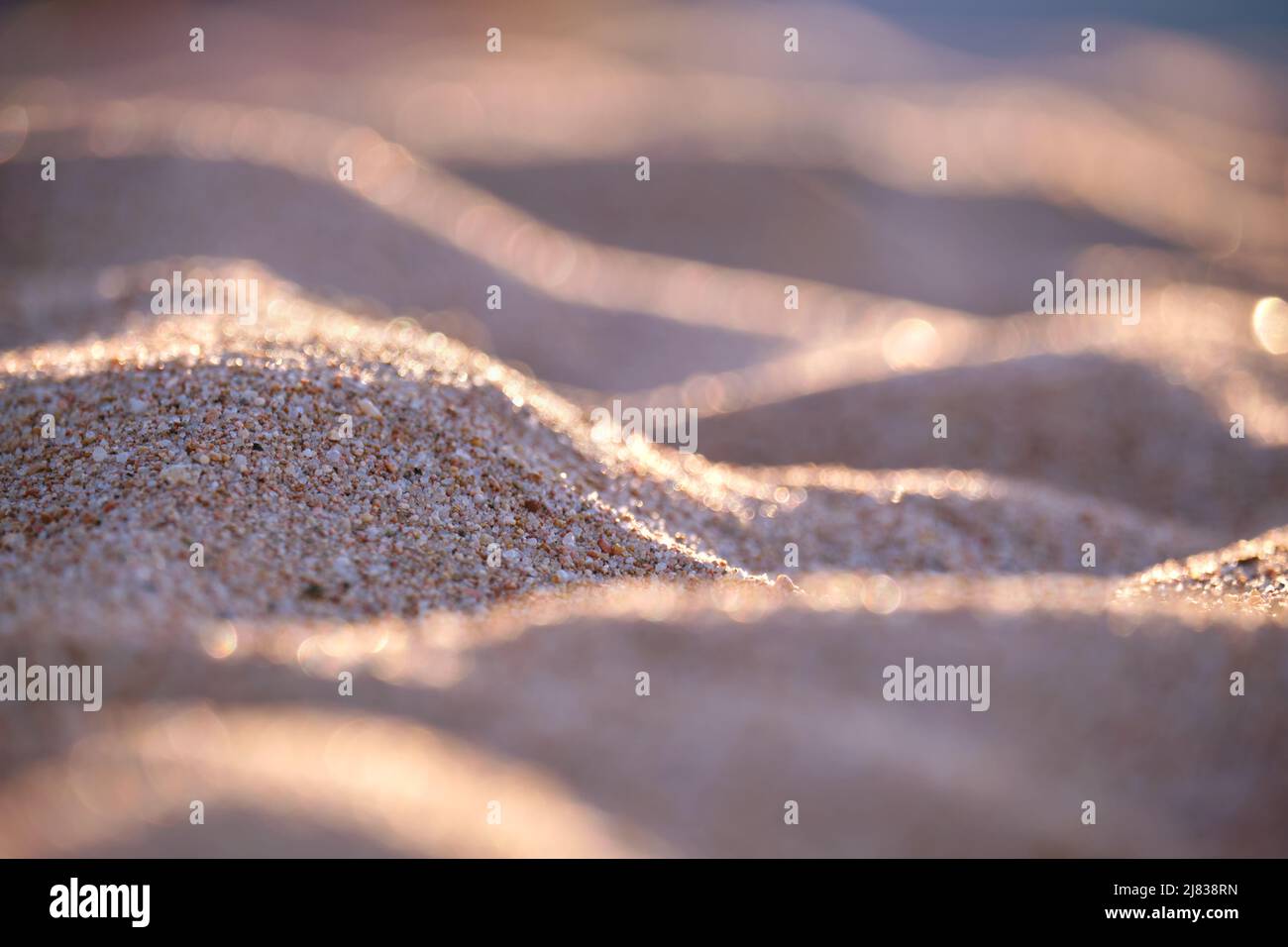 Close up of clean yellow sand surface covering seaside beach ...