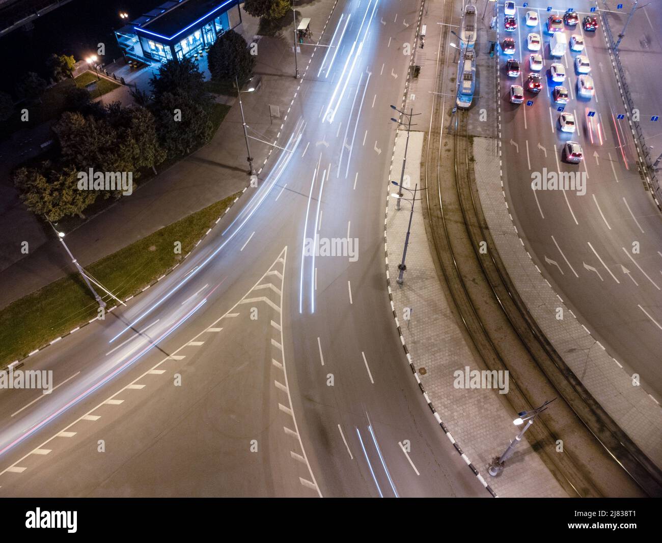 Night city center crossroad transport traffic in long exposure. Aerial ...