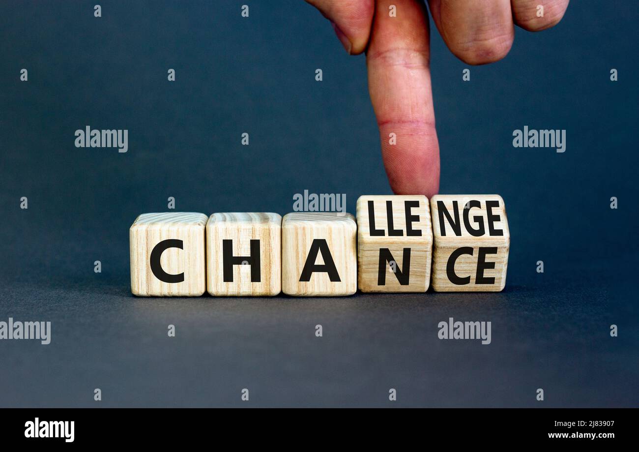 Chance or challenge symbol. Businessman turns wooden cubes and changes ...